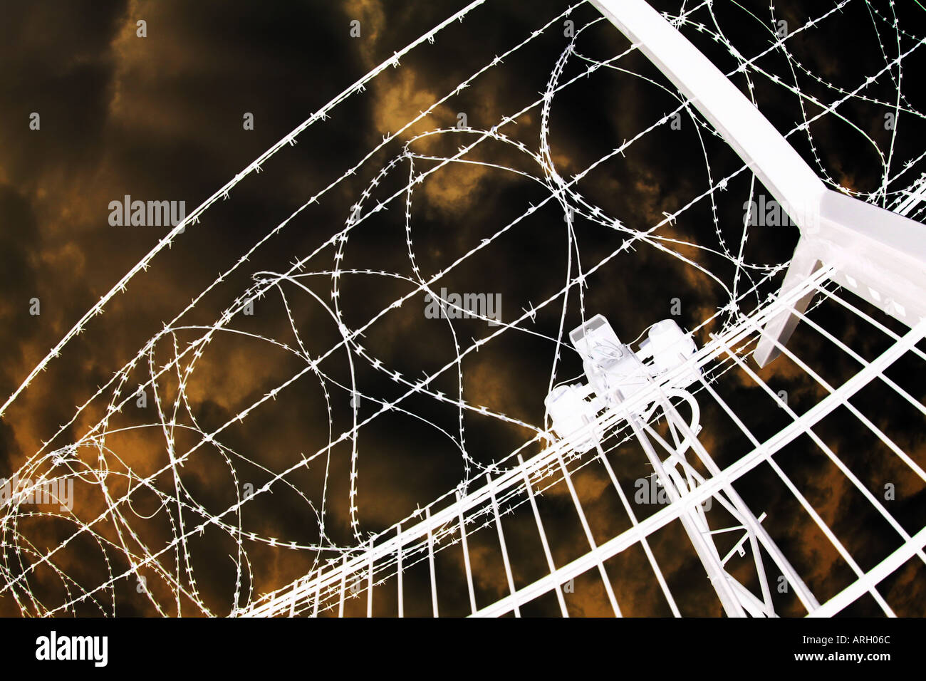 Security fence wire razor wire surveillance Stock Photo - Alamy
