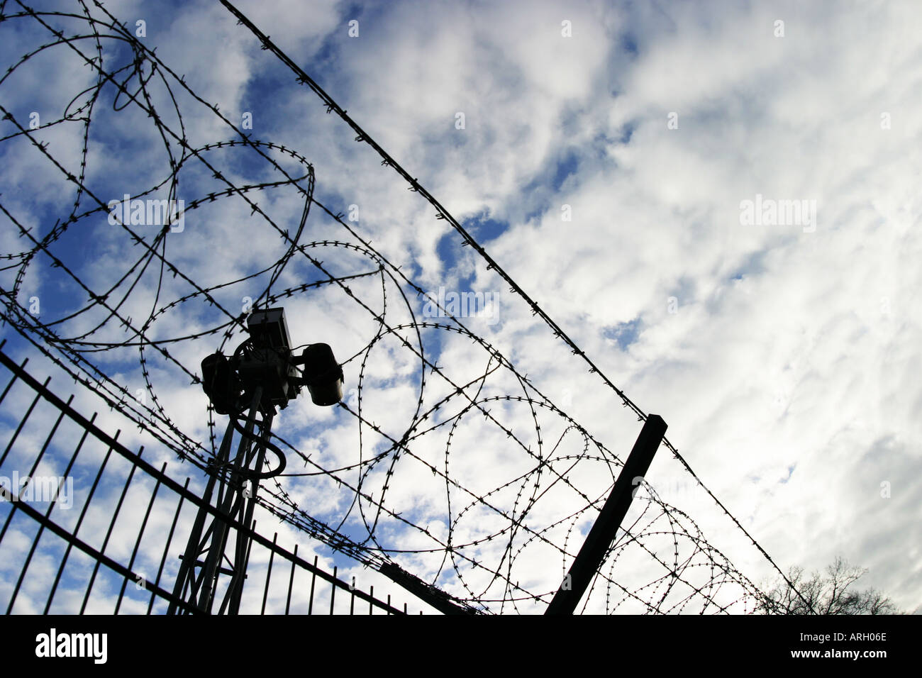 Security fence wire razor wire surveillance Stock Photo - Alamy