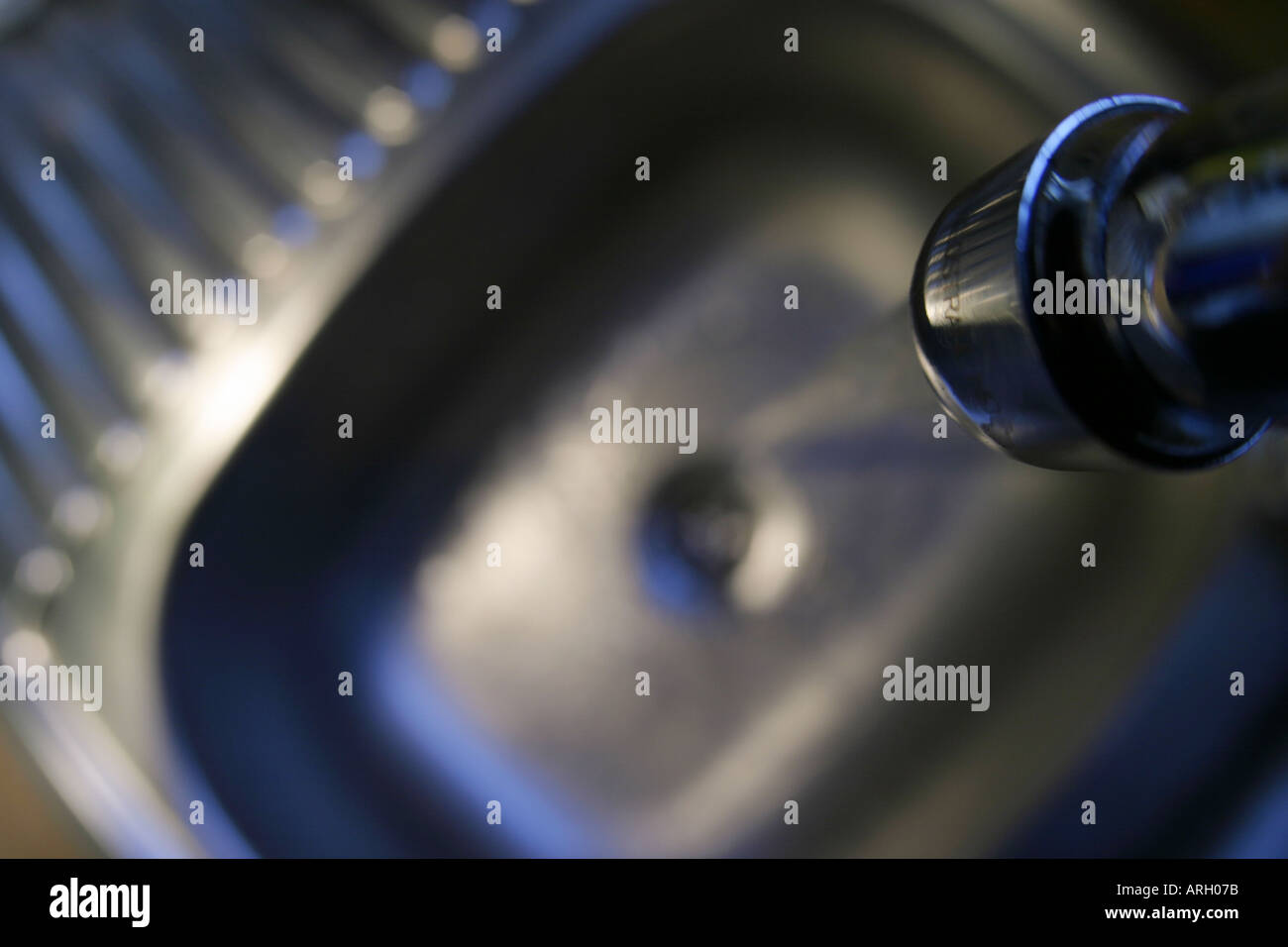 water draining down sink plug hole Stock Photo - Alamy