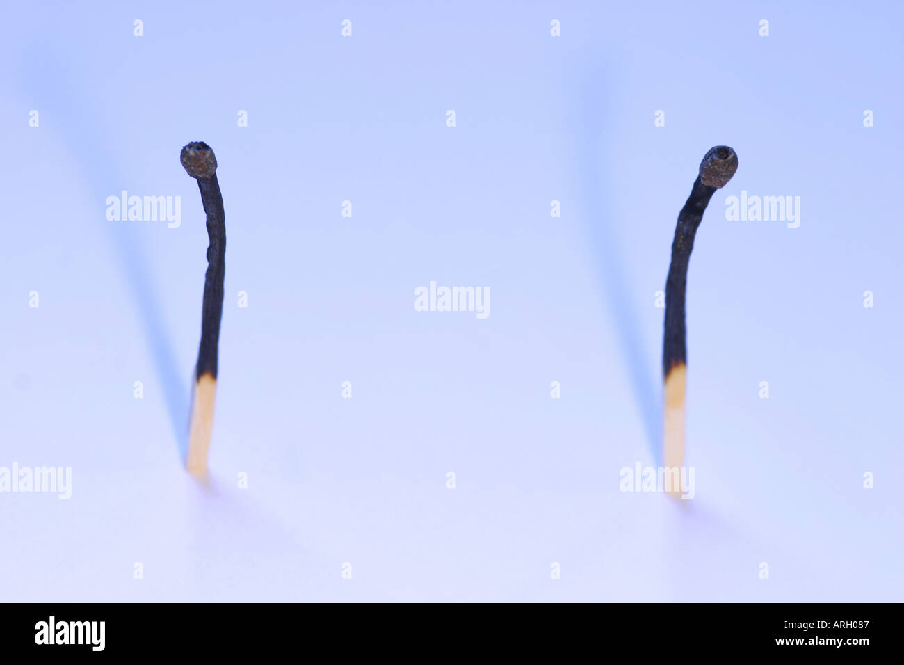 Two burn matches Stock Photo - Alamy