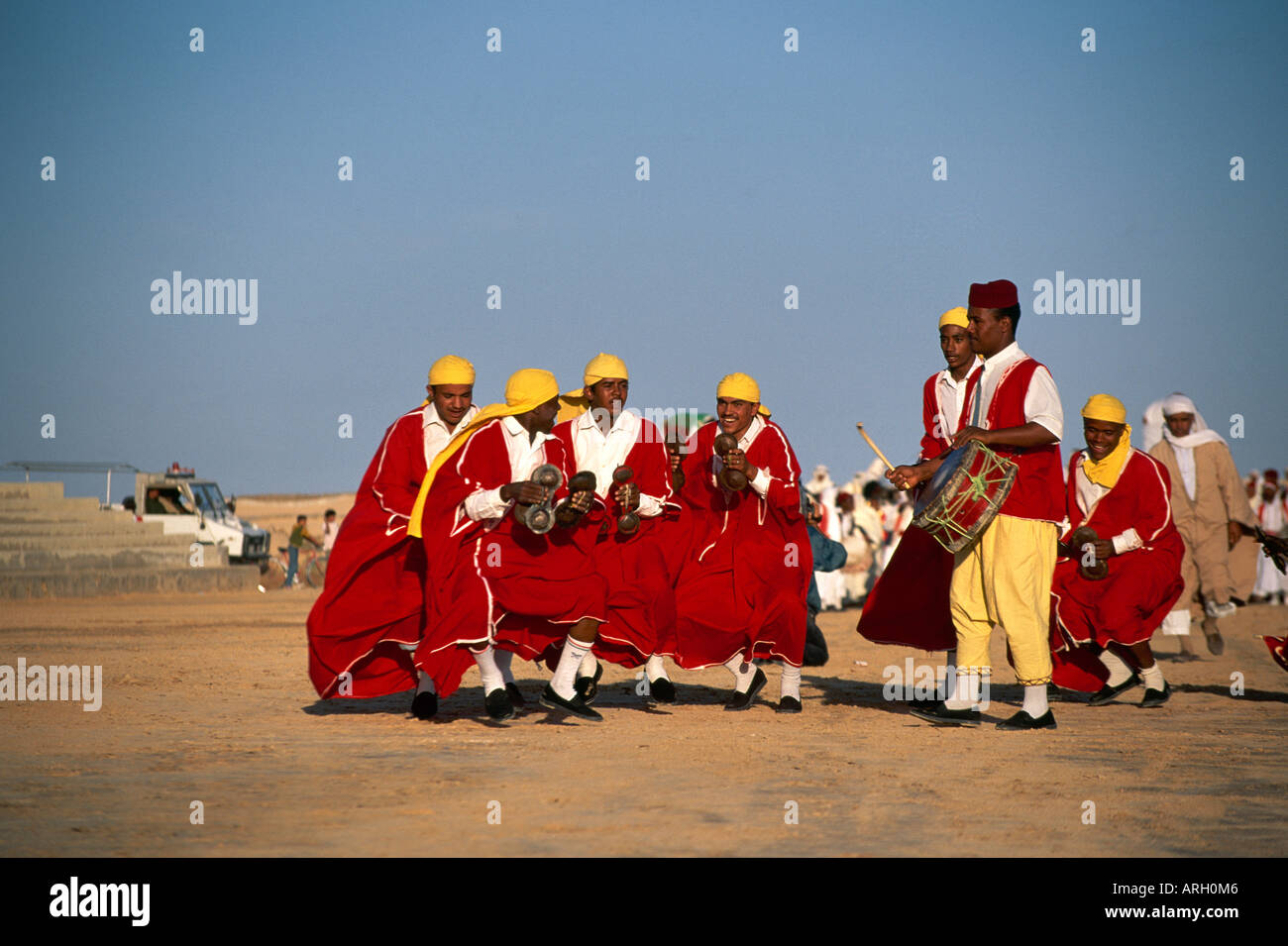 Brightly robed Arab musicians and dancers performing a traditional ...