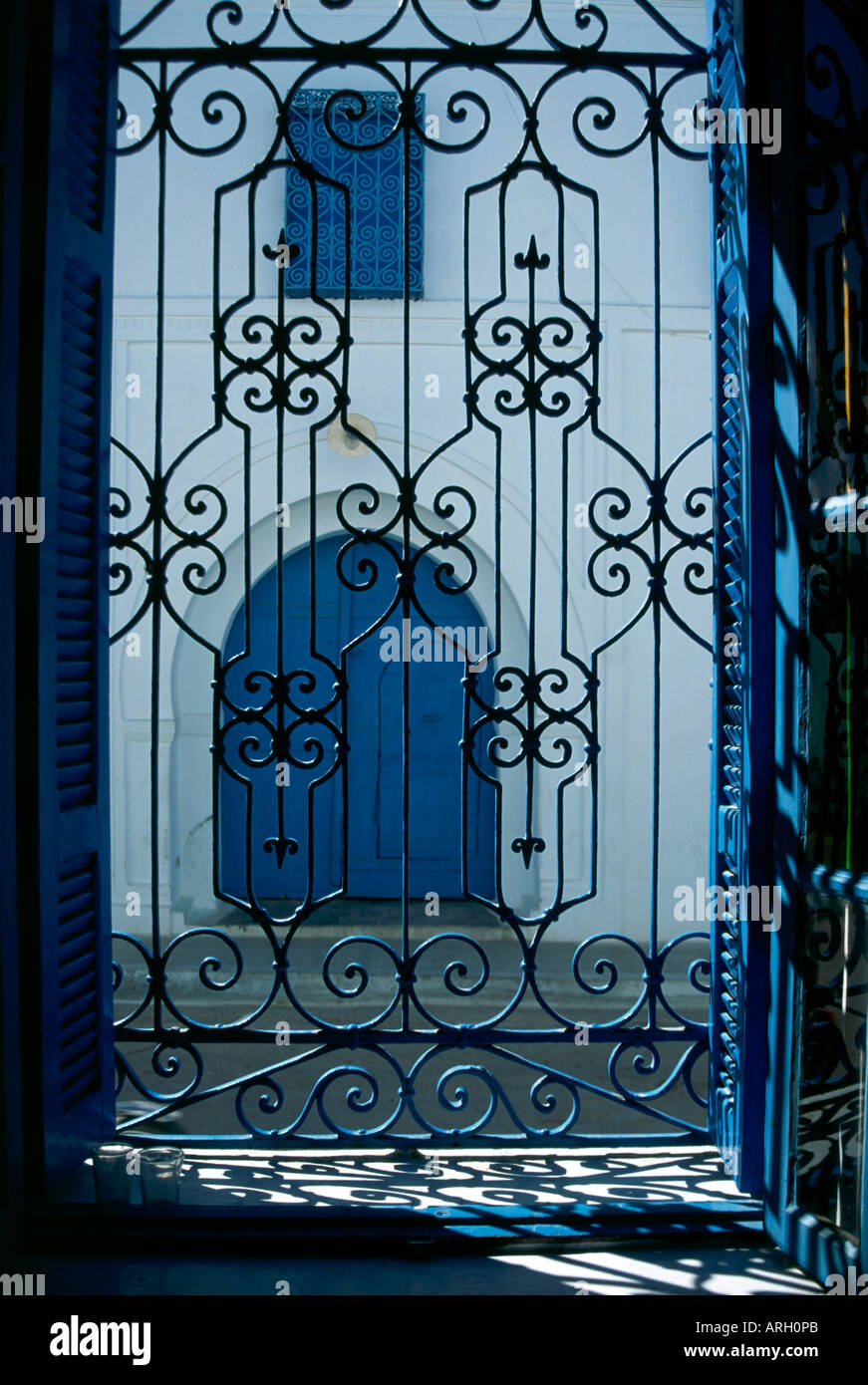 Detail of a wrought iron gateway framing the whitewashed facade Stock ...