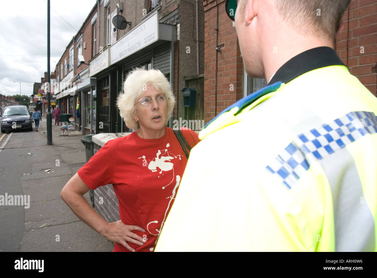 A police community support officer PCSO and old woman on duty in ...