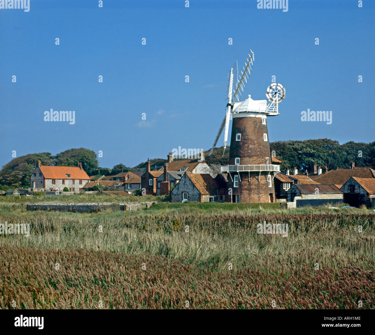 View of the village of Cley next the Sea dominated by a windmill over a ...