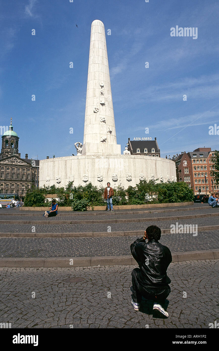 A sightseer posing in front of the towering phallic National Monument ...