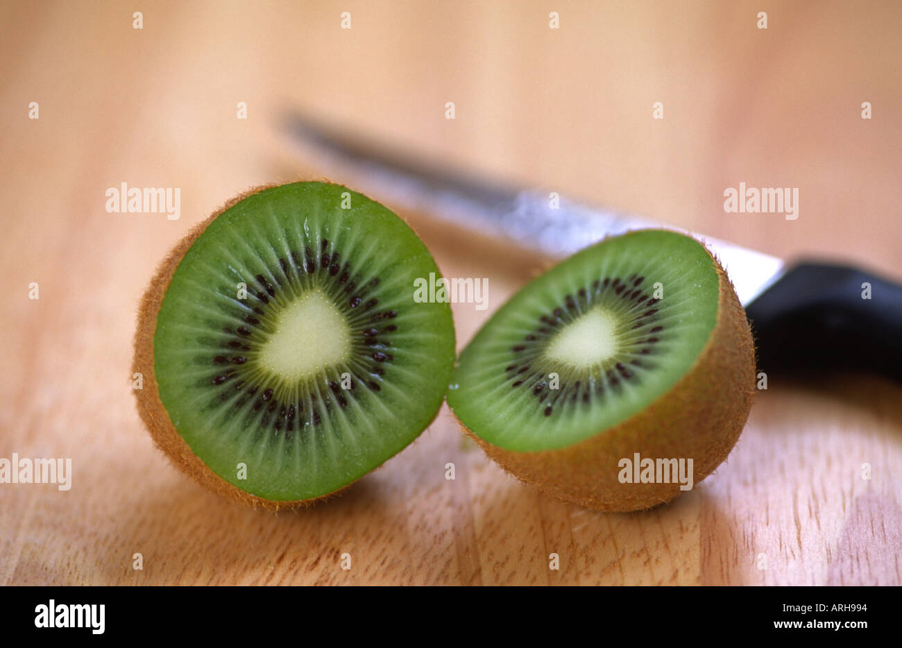 Kiwi Fruit cut in half to show seeds Stock Photo - Alamy