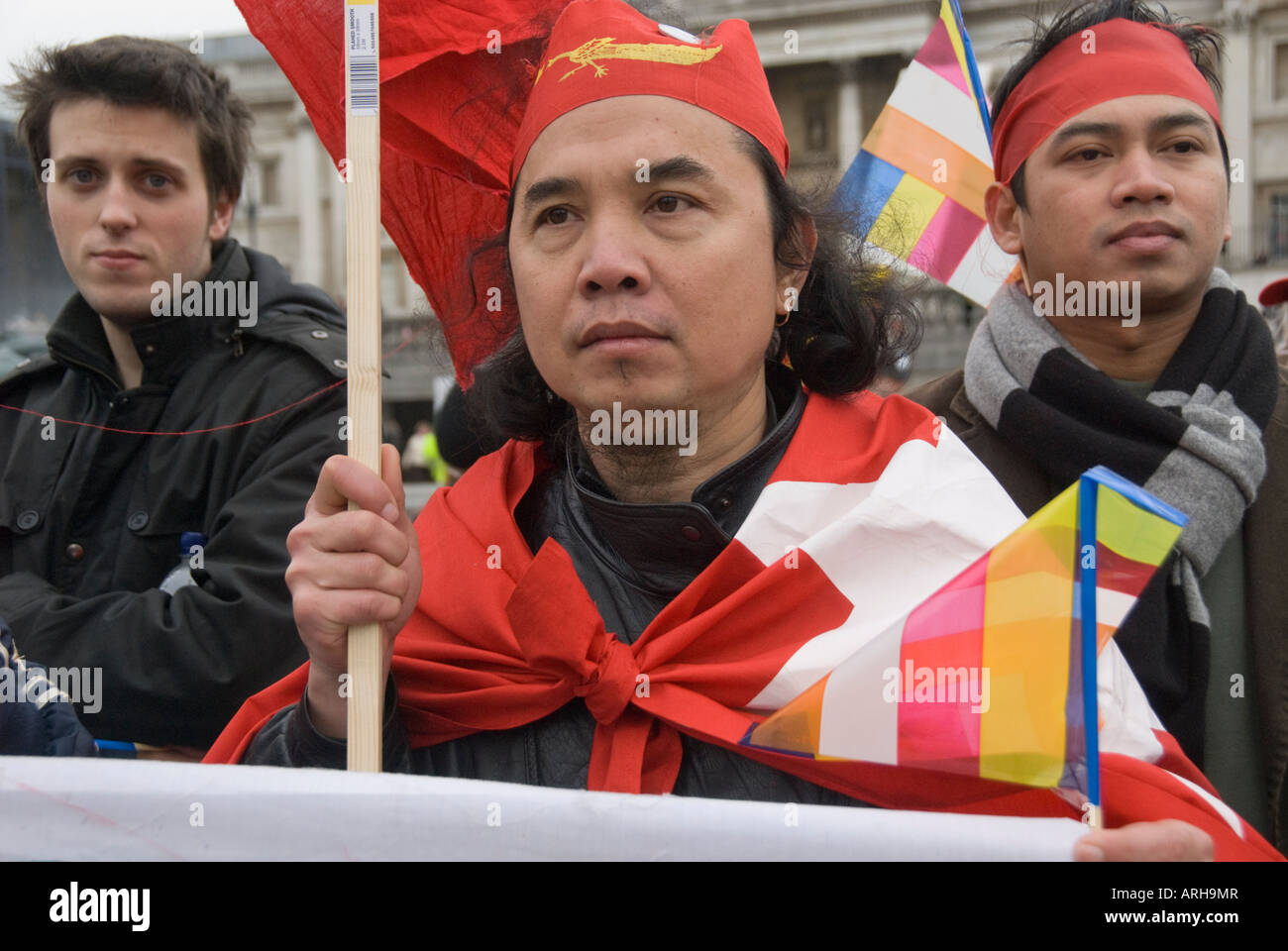 Man wearing Burmese freedom flag and red fighting peacock headband ...