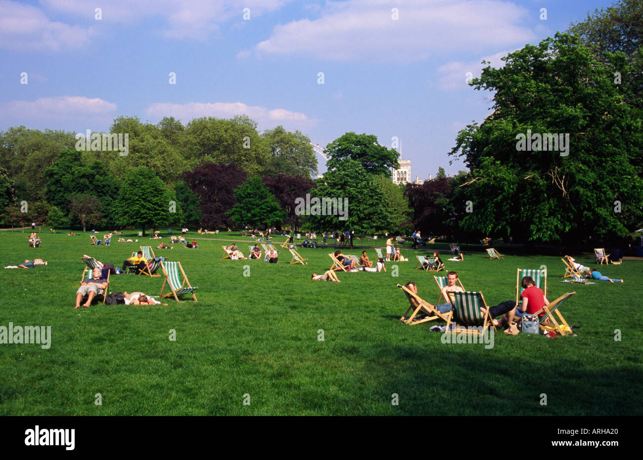 People relaxing in St James's Park Central London Summer time on a hot ...
