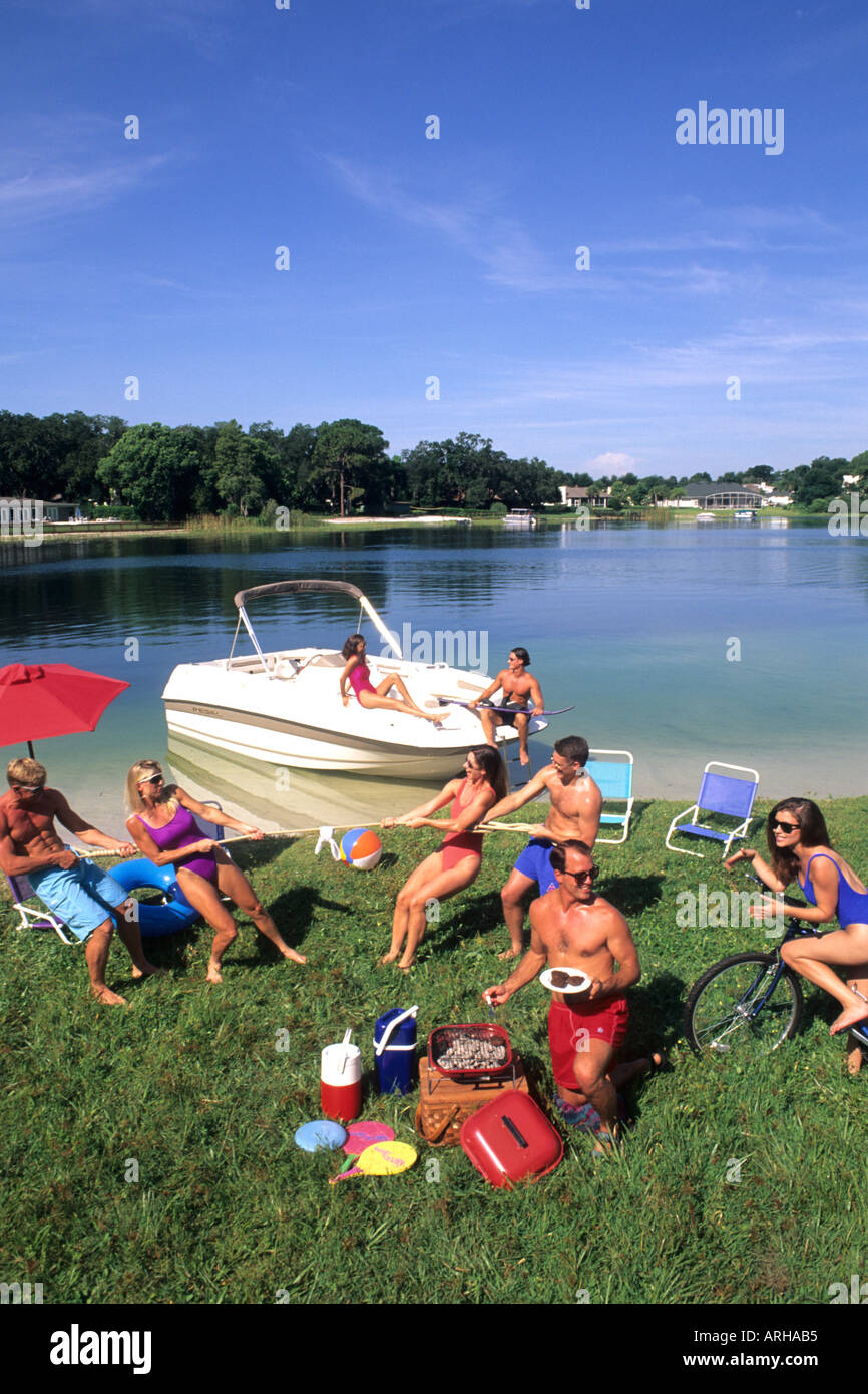 Couples enjoying a boating beach party Stock Photo - Alamy