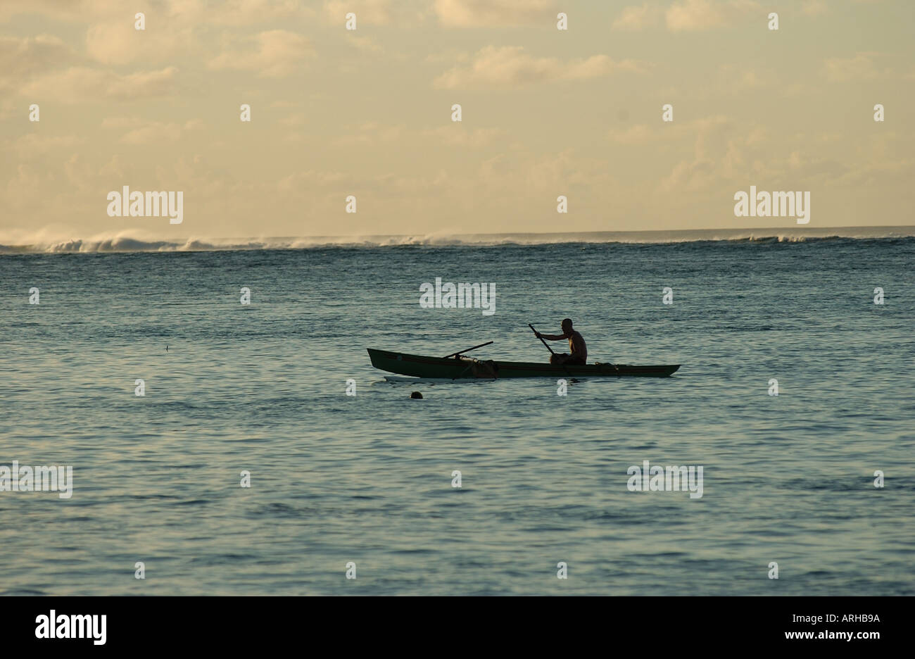 Silhouette of a man rowing a boat in the sea Moorea Tahiti French ...