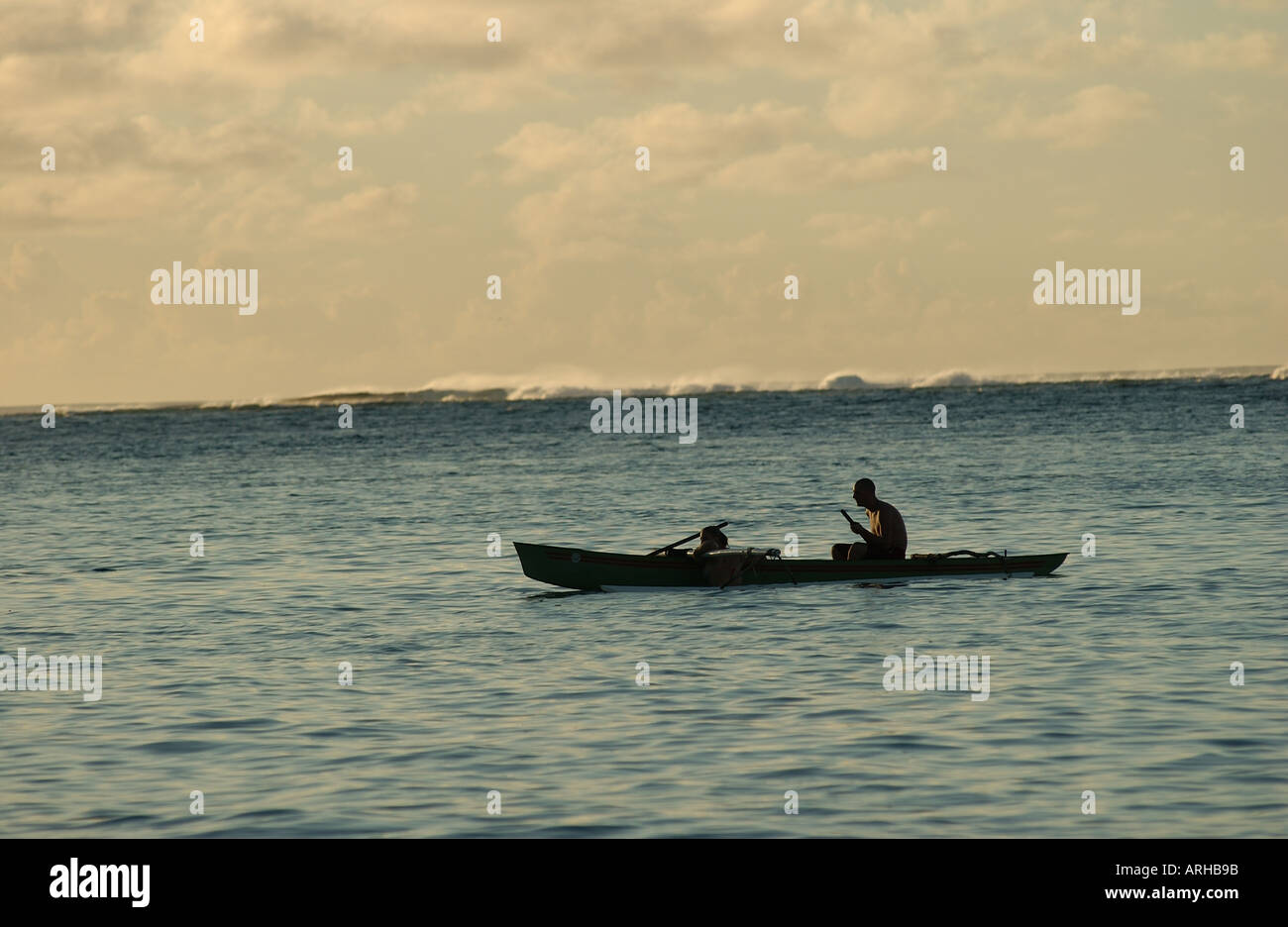 Silhouette of a man rowing a boat in the sea Moorea Tahiti French ...