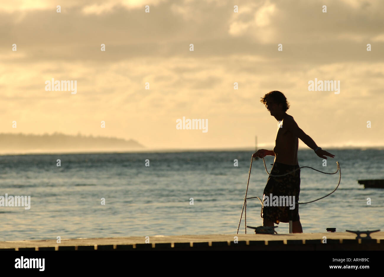 A man standing on a pier Moorea Tahiti French Polynesia South Pacific ...