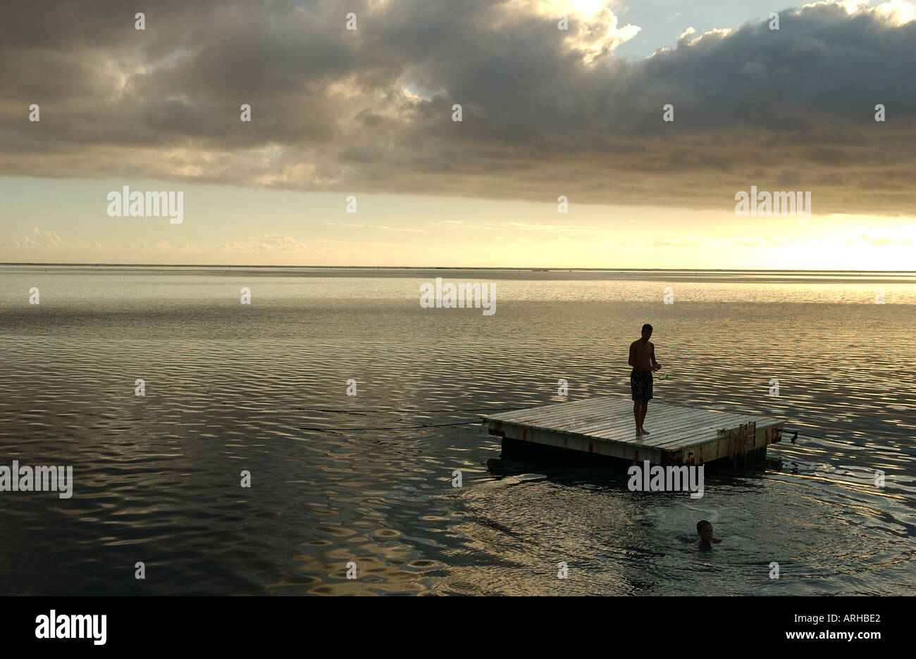 A man standing on a raft in the sea Moorea Tahiti French Polynesia ...