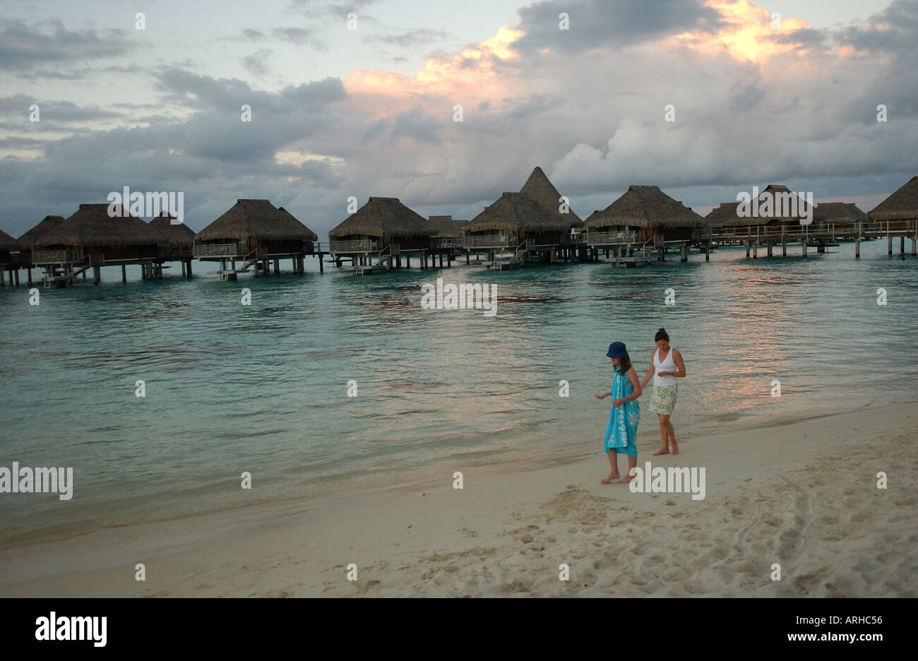Two young women walking on a beach Moorea Tahiti French Polynesia South ...