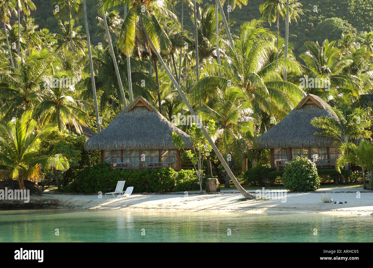 Thatched houses on a beach Moorea Tahiti French Polynesia South Pacific ...