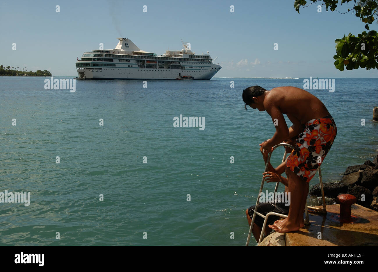 A young man on a pier Moorea Tahiti French Polynesia South Pacific ...