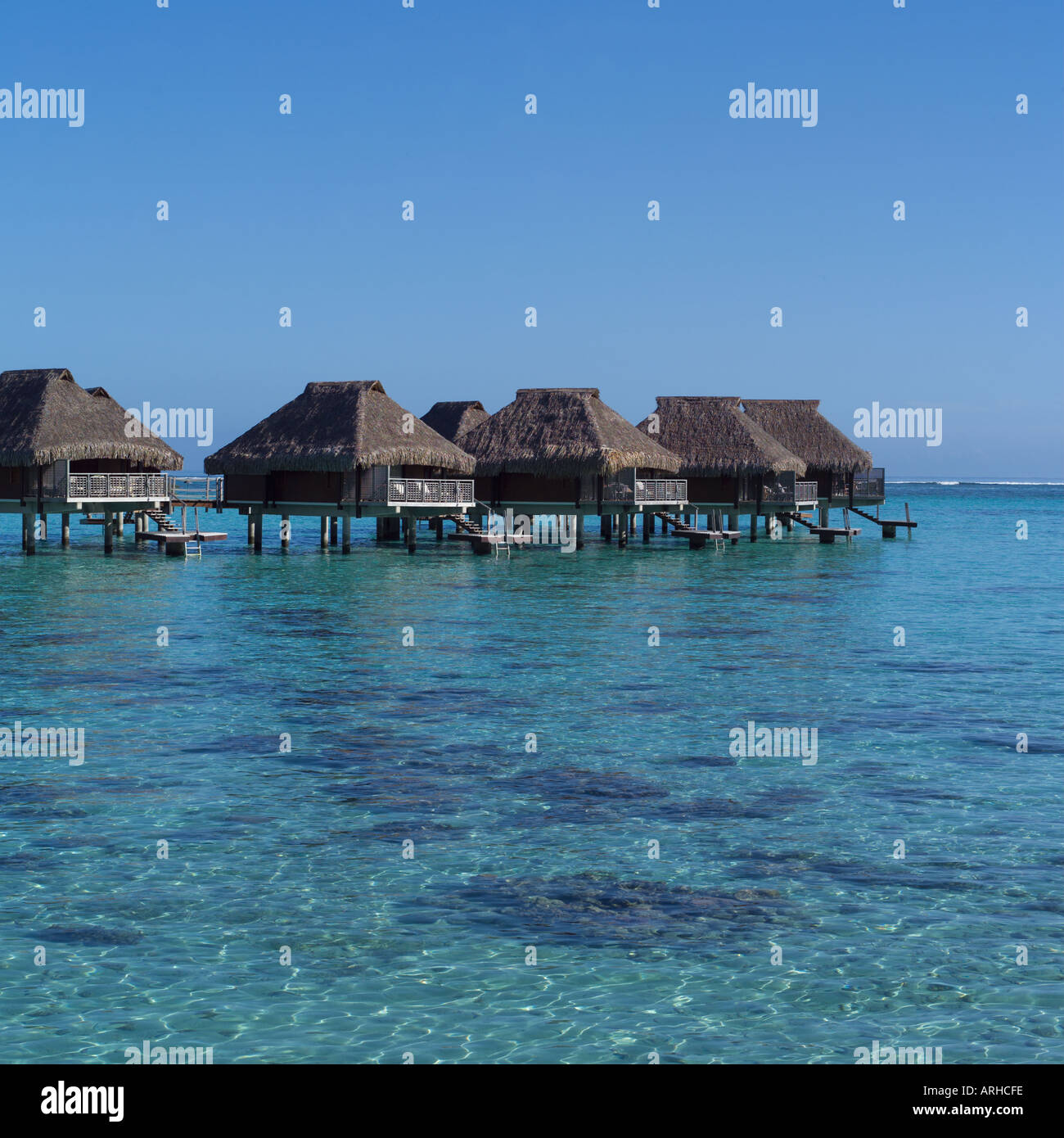 Sunrise with over water huts in tahiti hi-res stock photography and ...