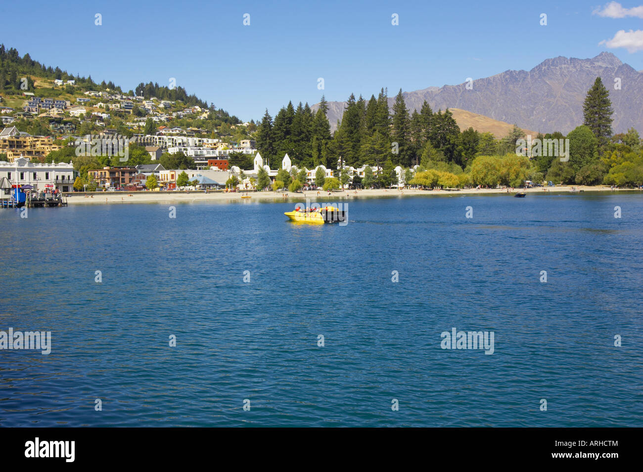 A land view surrounded with blue sky and blue water Stock Photo - Alamy