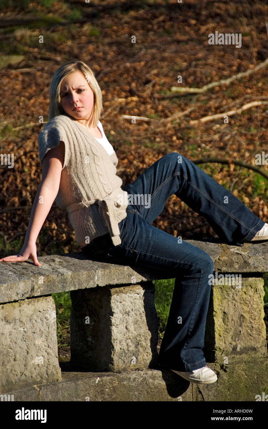 teenage girl sat on stone balustrade Stock Photo - Alamy