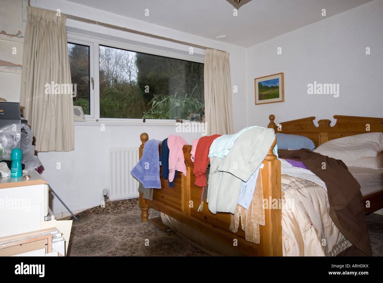 Messy bedroom with clothes scattered Stock Photo - Alamy