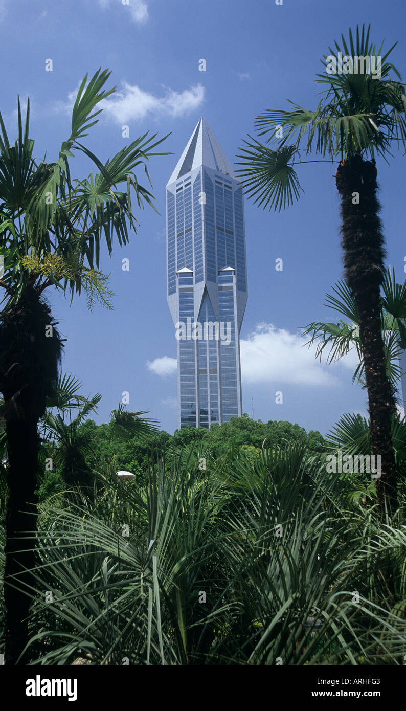 Modern skyscraper framed by green trees of Renmin Park in Shanghai ...