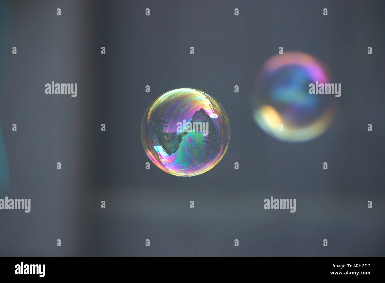 Bubble floating around against a grey background Stock Photo - Alamy