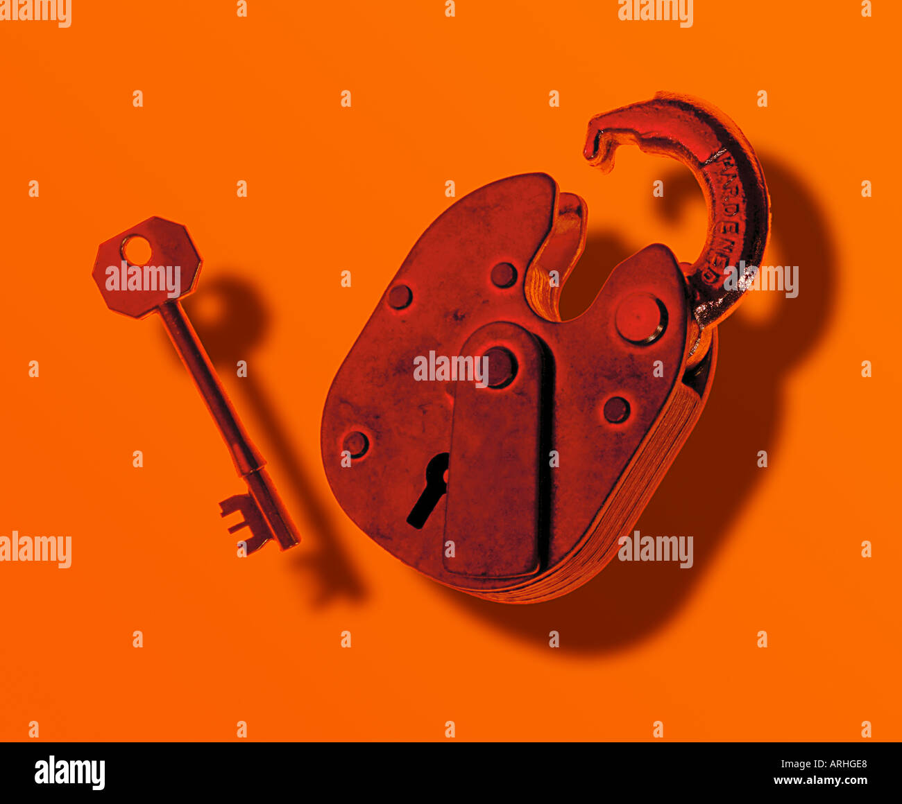 PADLOCK AND KEY CASTING SHADOW ON RED ORANGE BACKGROUND Stock Photo - Alamy