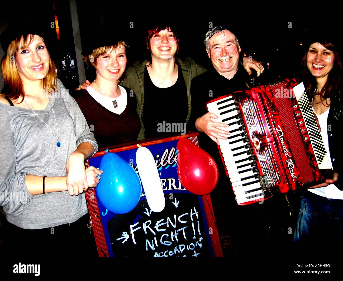 Revellers with accordionist Marcel Dupont celebrate French theme night ...