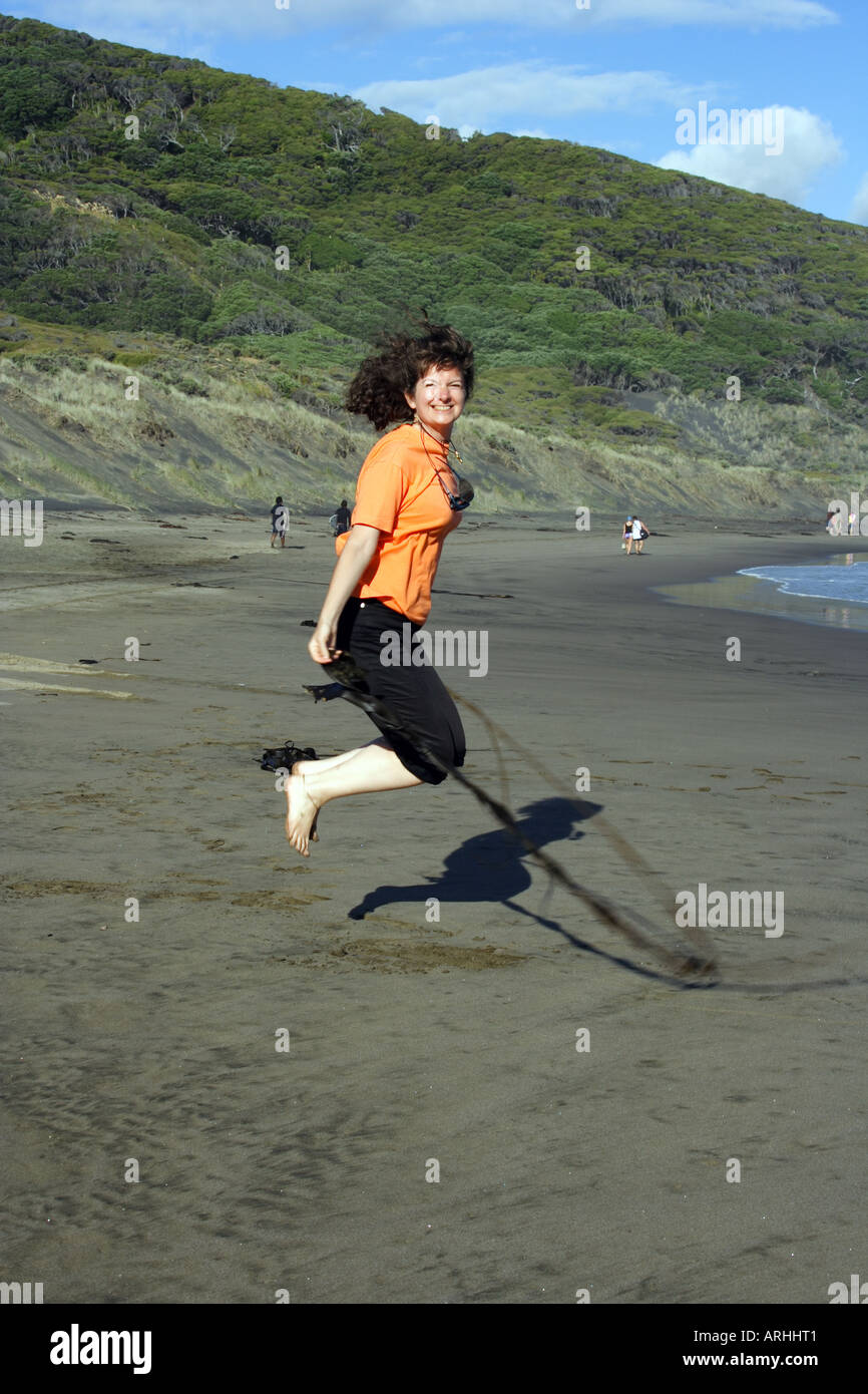 Woman skipping beach hi-res stock photography and images - Alamy