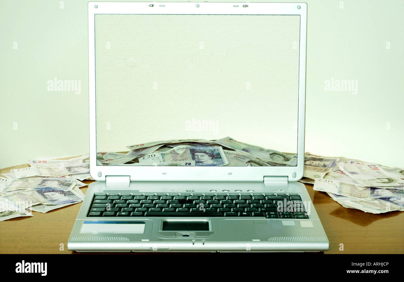 Laptop computer with money Stock Photo - Alamy