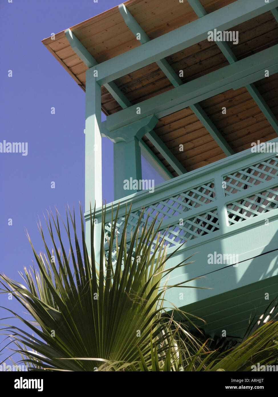 Green wooden balcony with a palm tree and a blue sky Stock Photo - Alamy