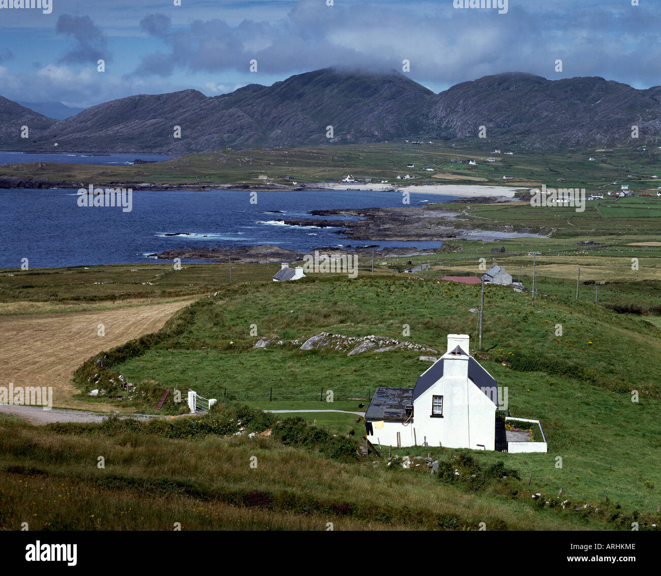 The village of Allihies is surrounded by lush green meadows beneath the ...