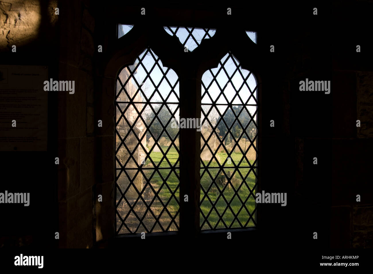 St Michael's church window showing graveyard Stock Photo - Alamy