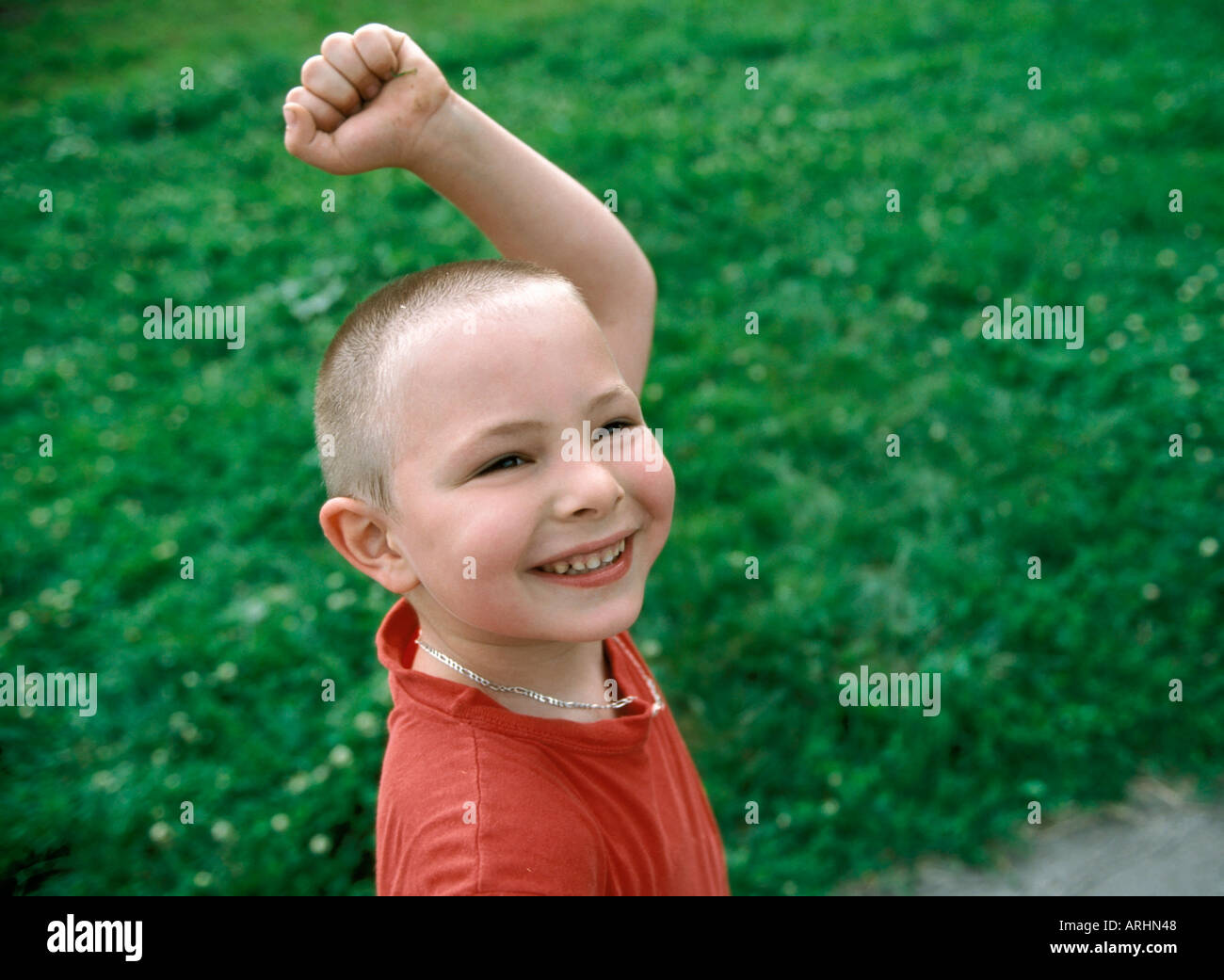 happy boy with one arm up MR8402 Stock Photo - Alamy