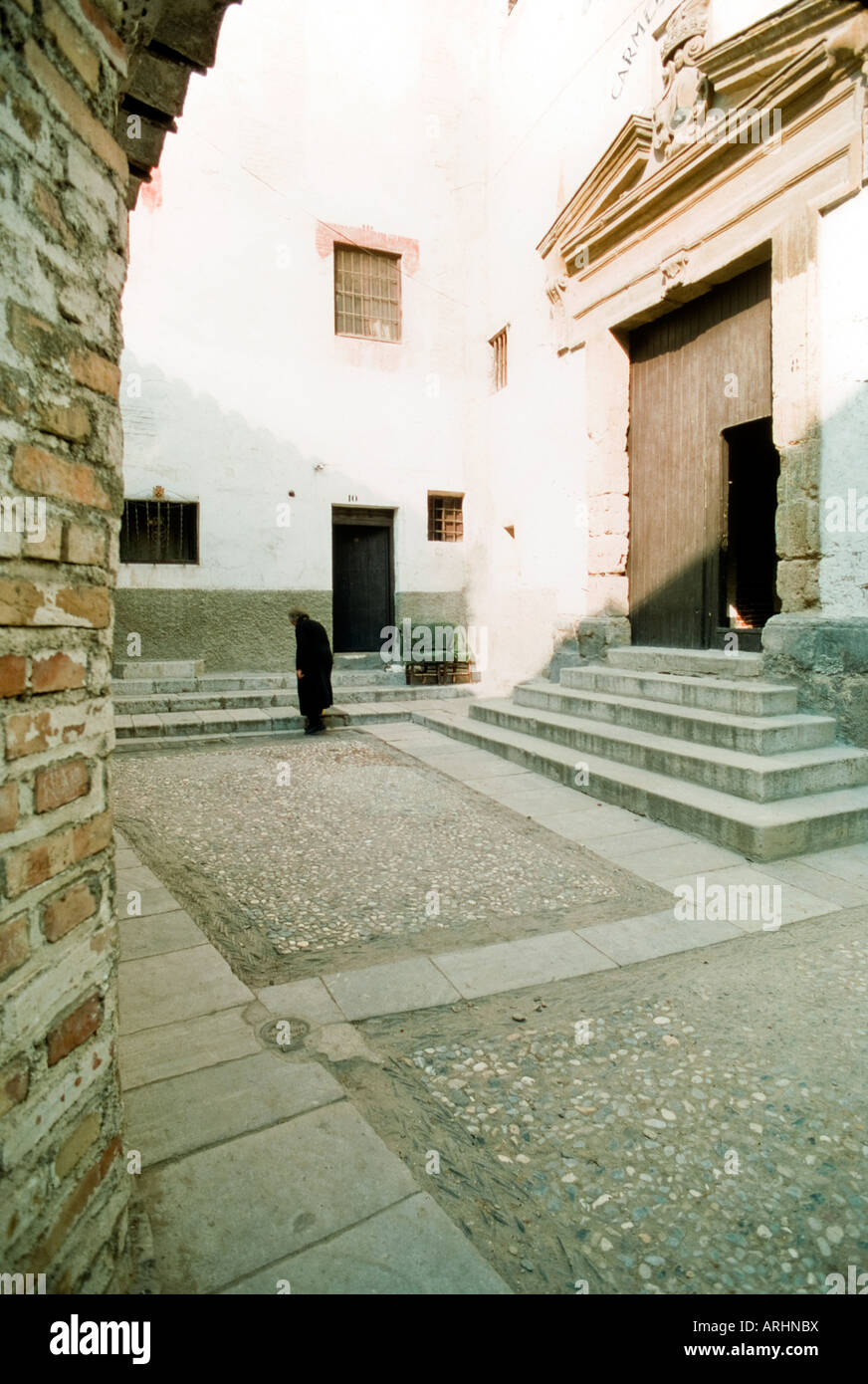 Lonely human in a courtyard within the Alhambra Stock Photo - Alamy