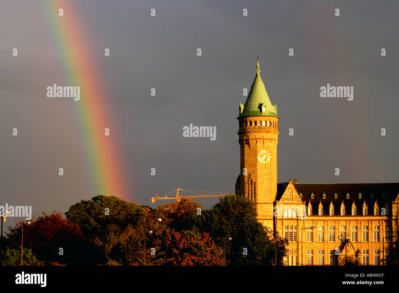 Evening light on a building and a rainbow Stock Photo - Alamy