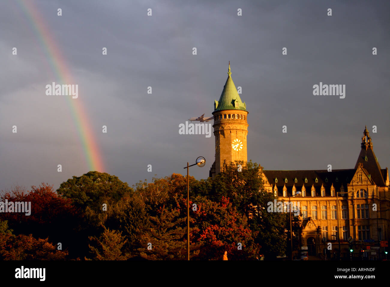 Evening light on a building and a rainbow Stock Photo - Alamy