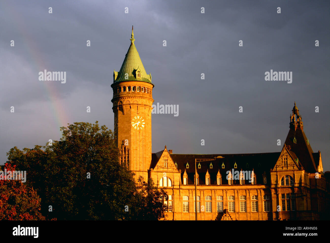 Evening light on a building and a rainbow Stock Photo - Alamy