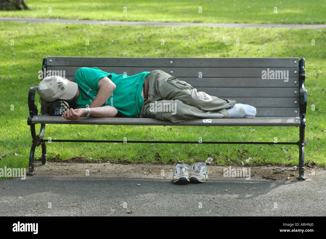 Man sleeping on the bench in the Historic New Haven Green during summer ...