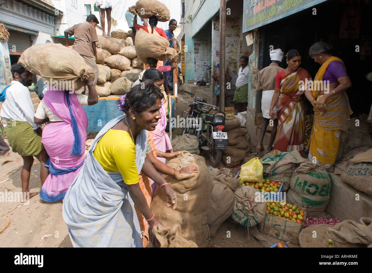 Women workers loading potatoes onto transport trucks, Tiruvannamalai ...
