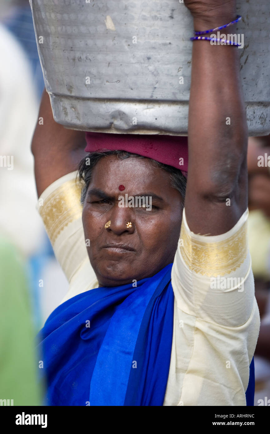 Indian women carrying an aluminum pot Stock Photo - Alamy