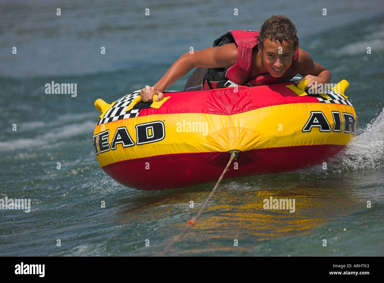 Boy riding a water tube Stock Photo - Alamy