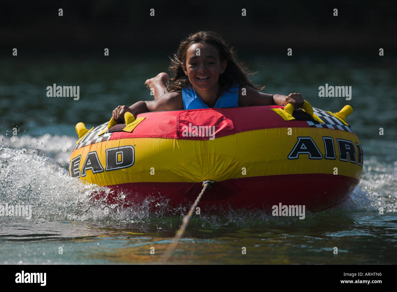 Girl enjoying the ride on a water tube Stock Photo - Alamy