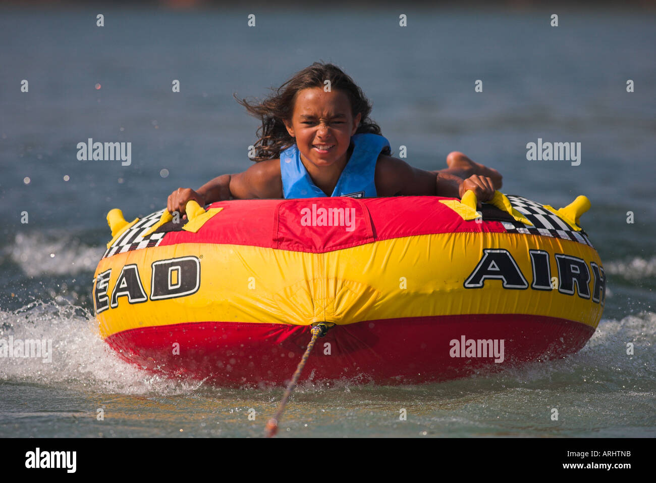 Girl enjoying the ride on a water tube Stock Photo - Alamy