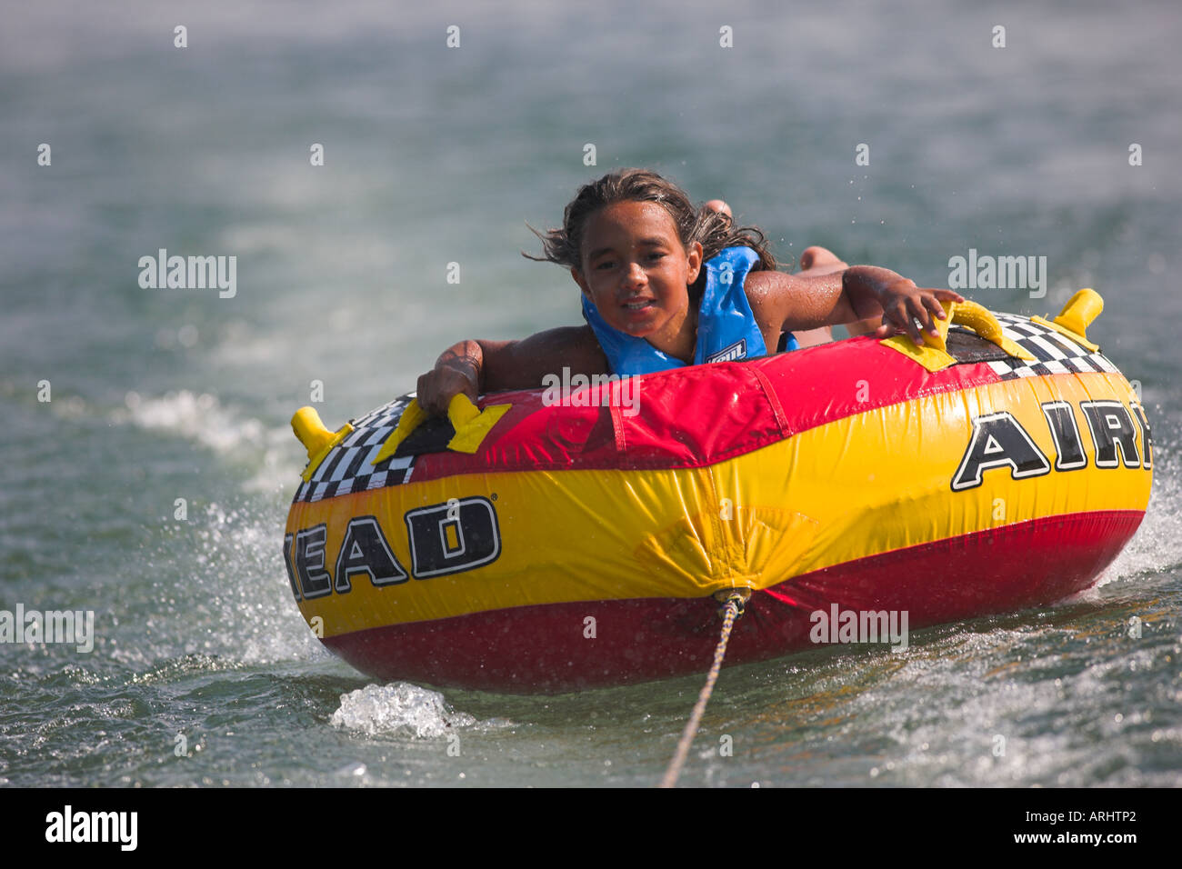 Girl enjoying the ride on a water tube Stock Photo - Alamy
