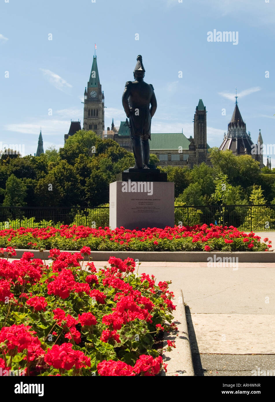 A statue of John By surrounded by colourful red flowers in Majors Hill ...