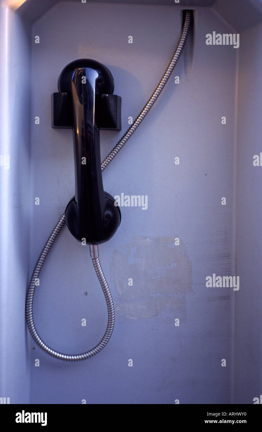 telephone receiver with cable without telephone hanging on the holder ...