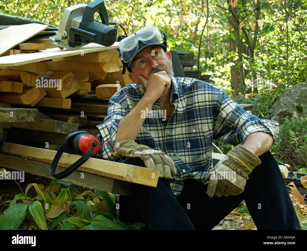 craftsman carpenter man with safety protective goggles and earmuffs ...