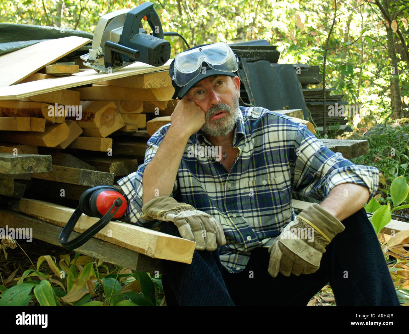 craftsman carpenter man with safety protective goggles and earmuffs ...
