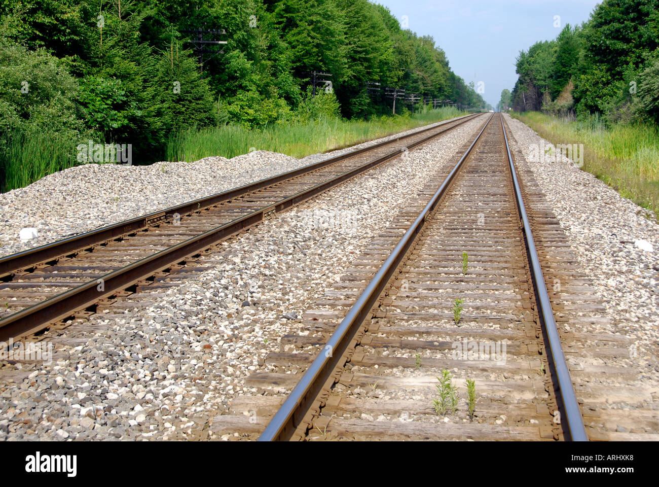 Two sets of railroad tracks lead to infinity Stock Photo - Alamy